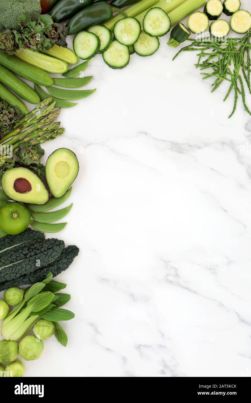 Plant based vegan health food with green vegetables & fruit forming a ...