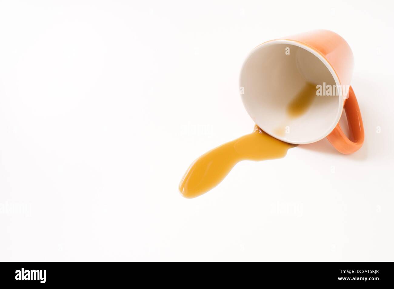 Spilled coffee on white table Stock Photo - Alamy