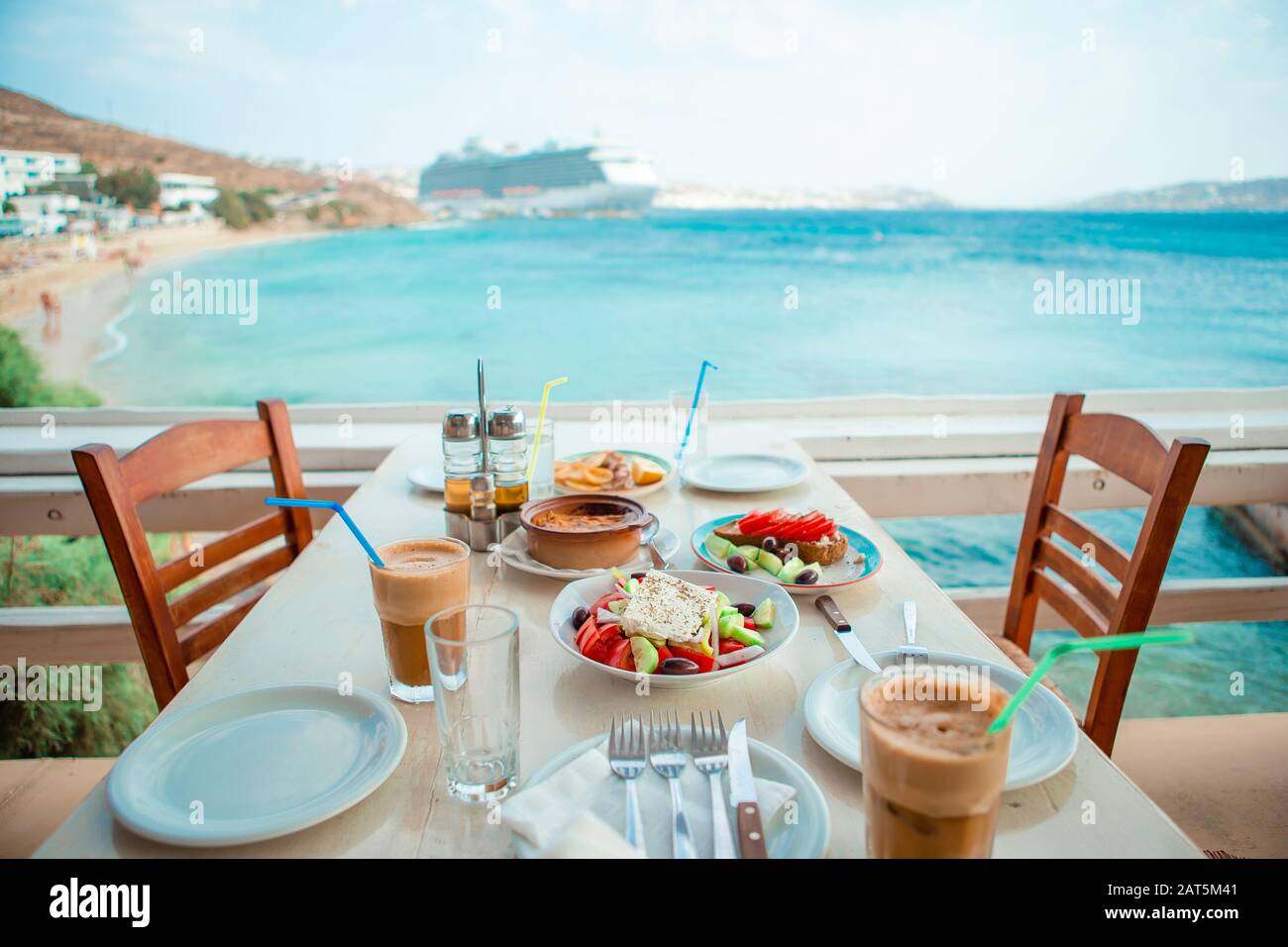 Outdoor cafe on a street of typical greek traditional village in Greece ...