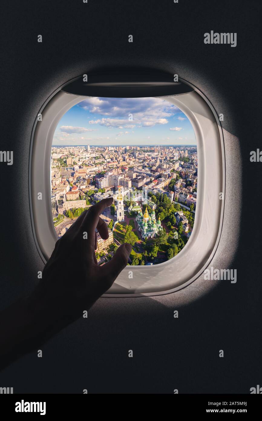 Airplane window with a aerial panorama of Kiev, Ukraine during a flight ...
