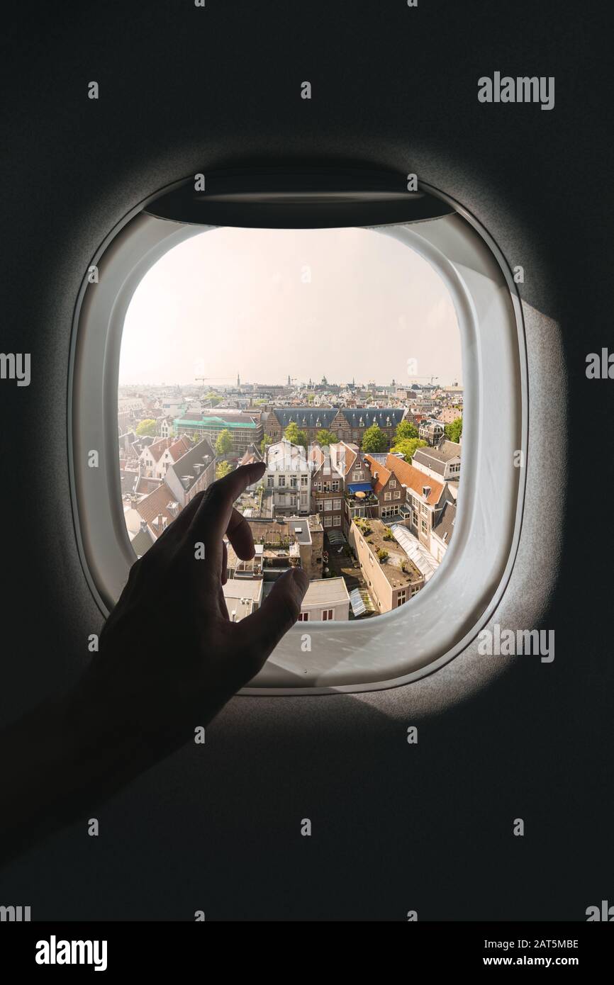 Airplane window with a aerial panorama of Amsterdam, Netherlands during ...