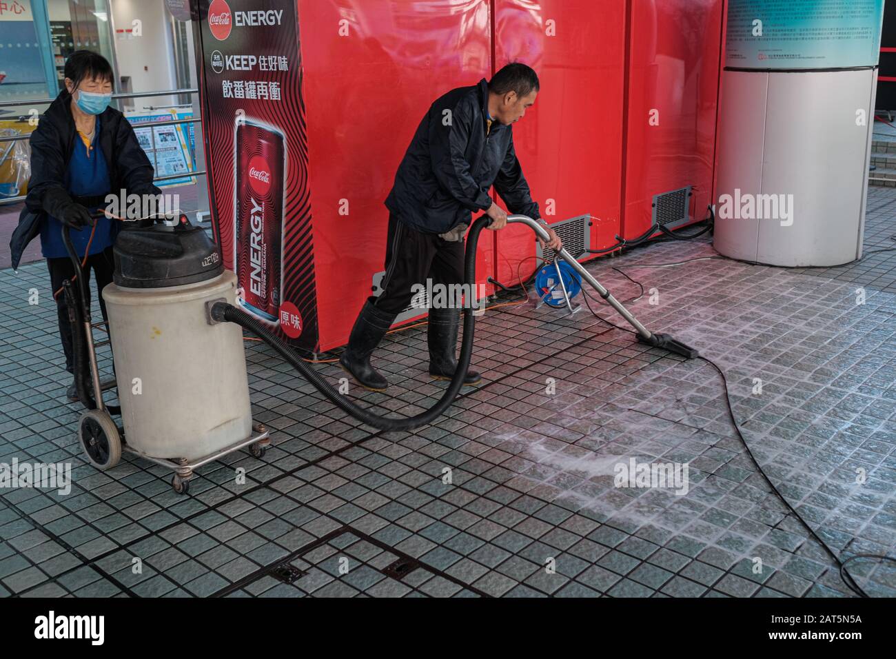 A street cleaner uses a floor scrubber to clean public area in Hong ...