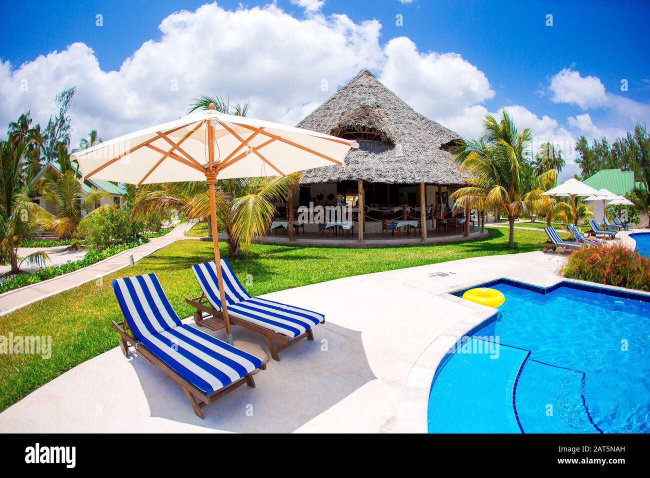 Beach lounge chairs on beautiful tropical luxury resort Stock Photo - Alamy