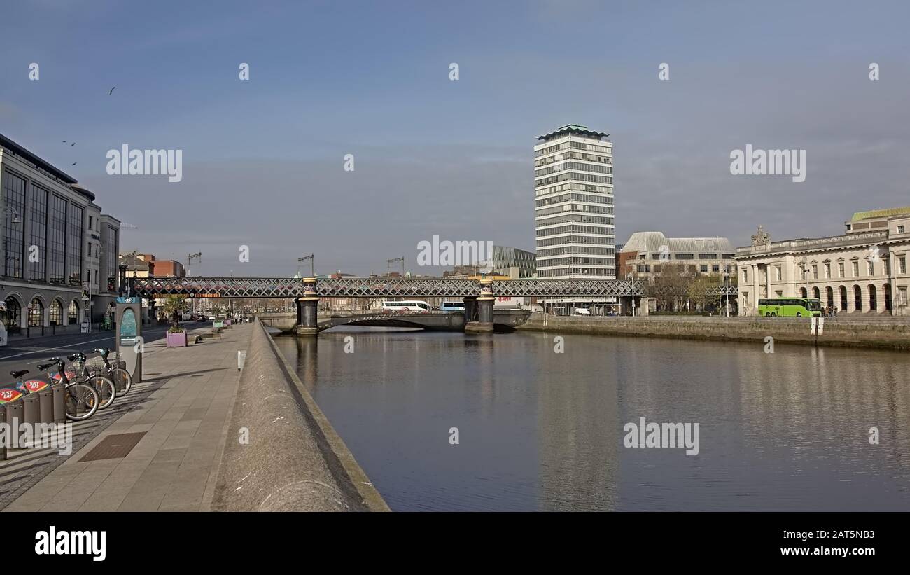 Liffey river, with railway bridge and apartmet skyscraper on the ...
