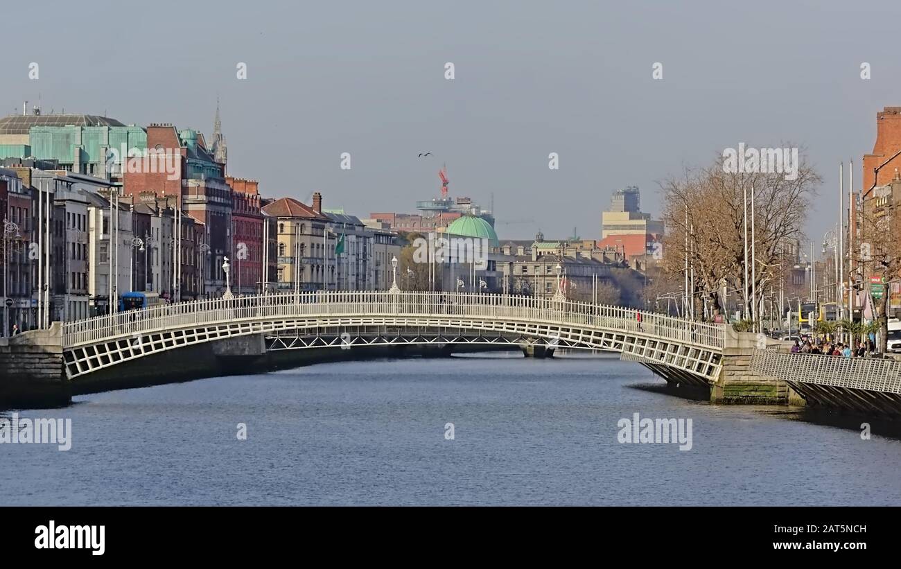 famous Ha`penny bridge over Liffey river in the city of Dublin, Ireland ...