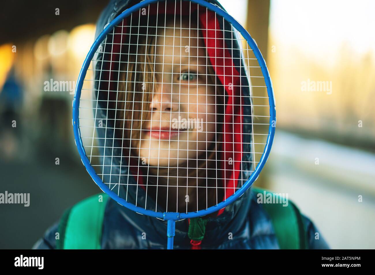 Boy looking through a badminton racket net Stock Photo - Alamy