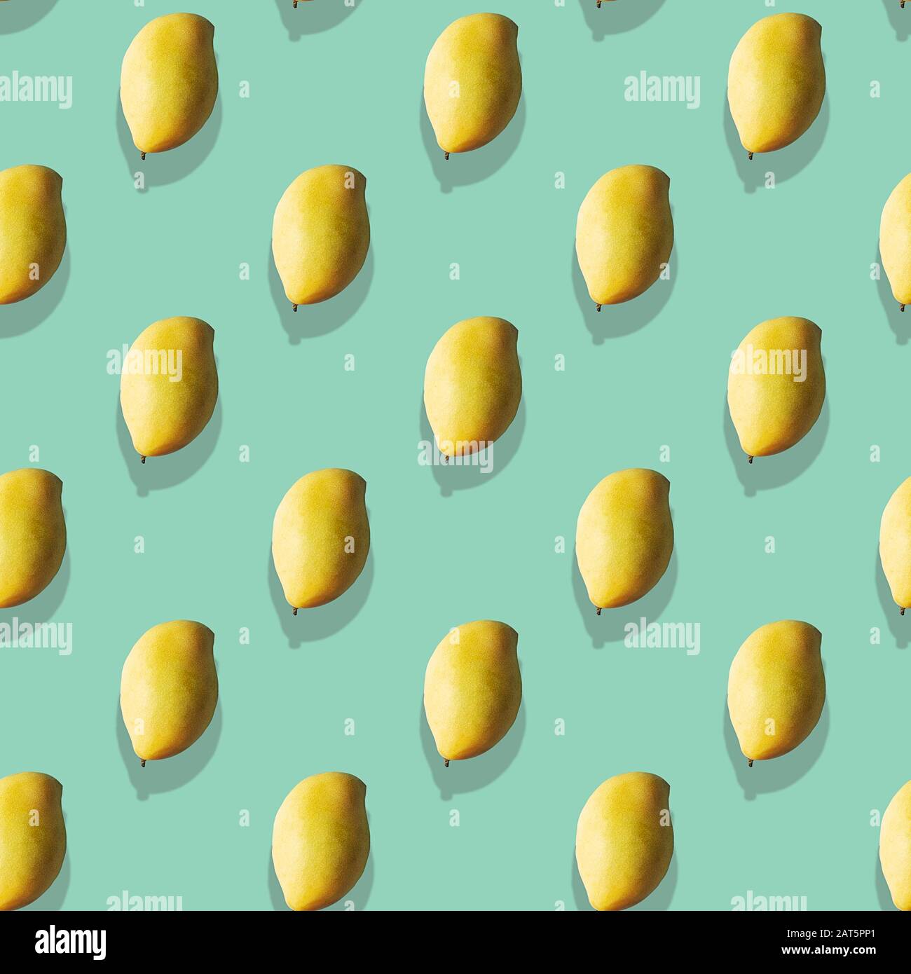 Flat lay Seamless Pattern made with ripe yellow mango fruit over mint ...