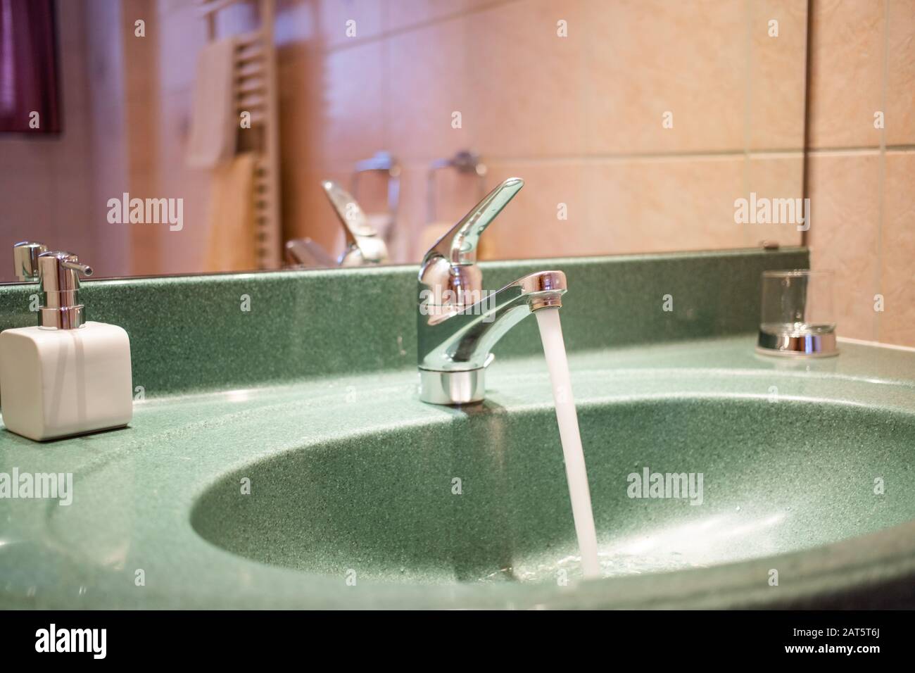 running tap water in bathroom Stock Photo - Alamy