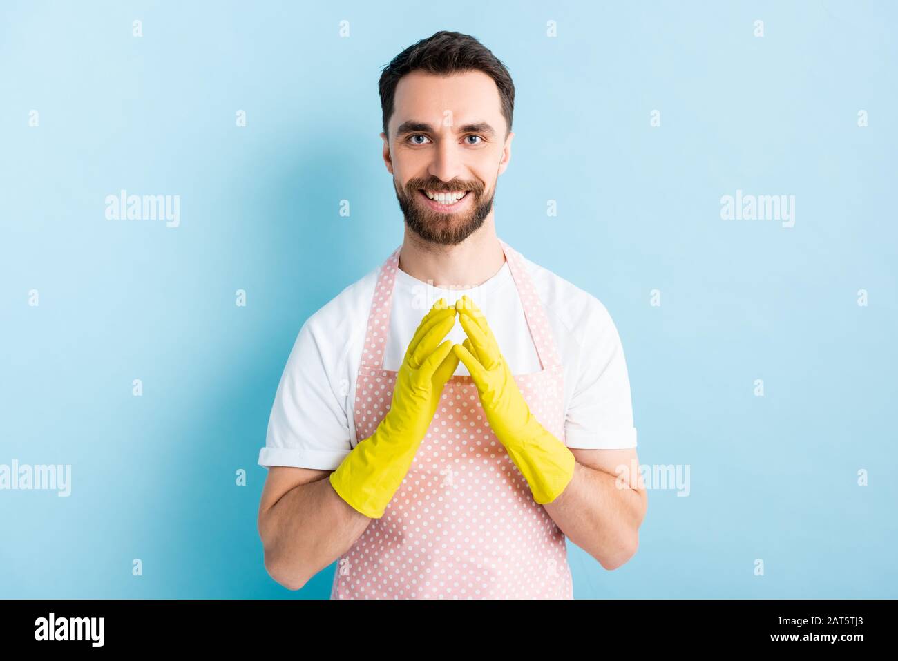 happy bearded man in yellow rubber gloves smiling on blue Stock Photo ...