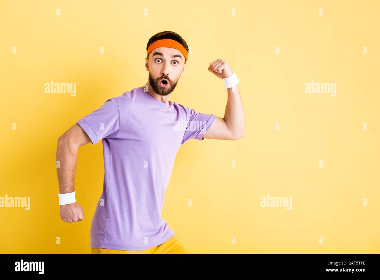 shocked bearded man running on yellow Stock Photo - Alamy