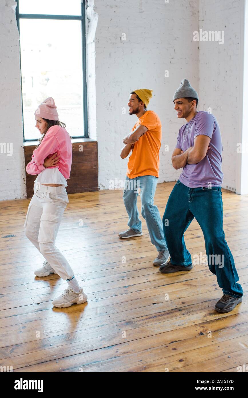 attractive girl with crossed arms breakdancing with stylish ...