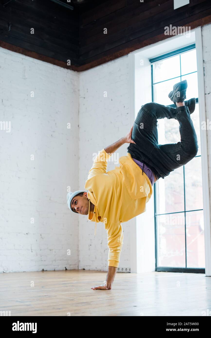 trendy man in hat breakdancing in dance studio Stock Photo - Alamy