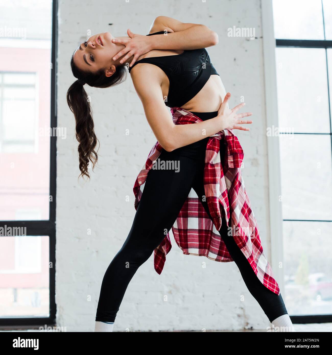 attractive girl touching face while dancing jazz funk Stock Photo - Alamy