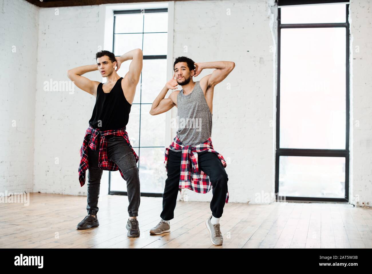 multicultural dancers posing while dancing jazz funk in dance studio ...