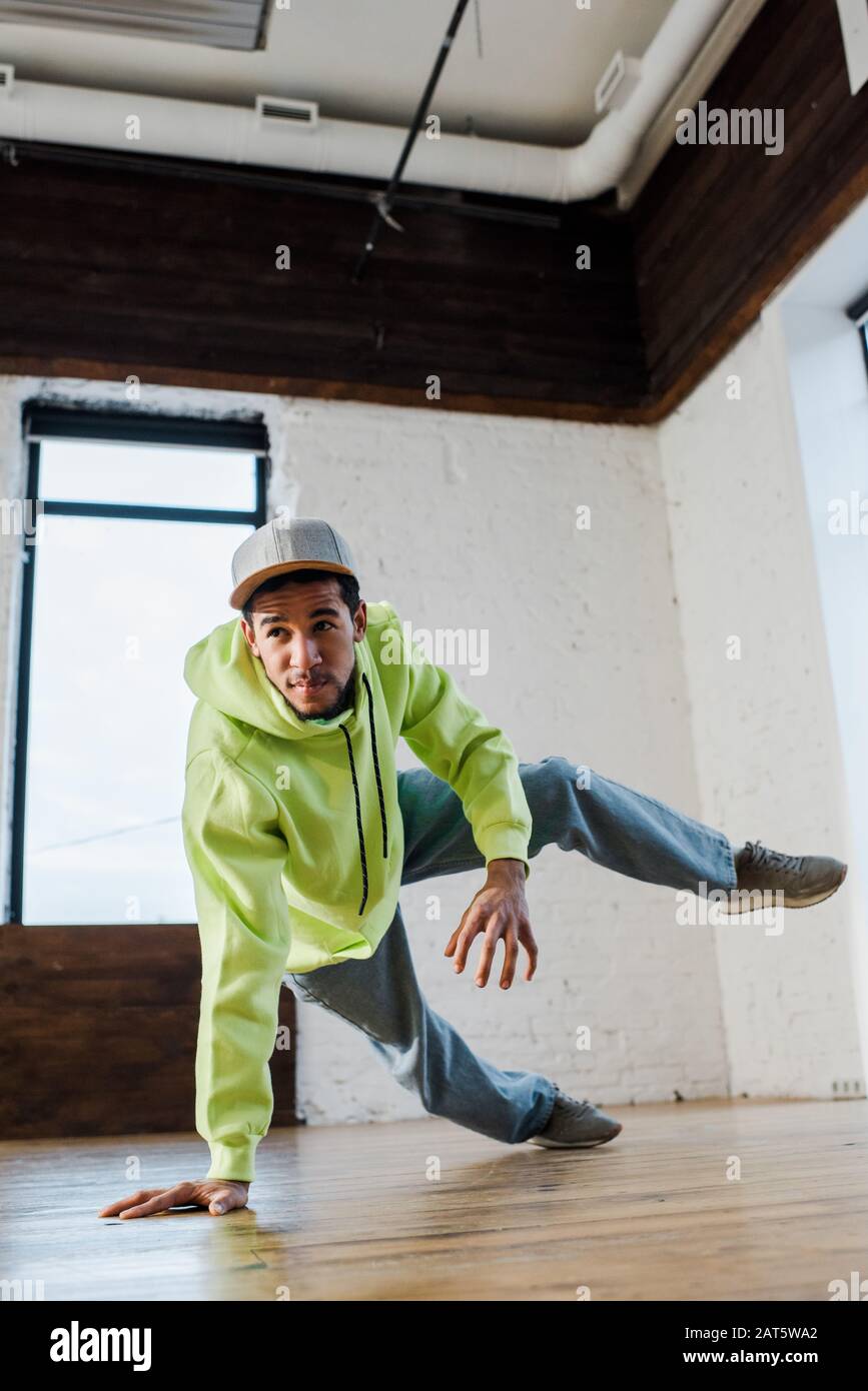 stylish and young african american man in cap breakdancing in dance ...