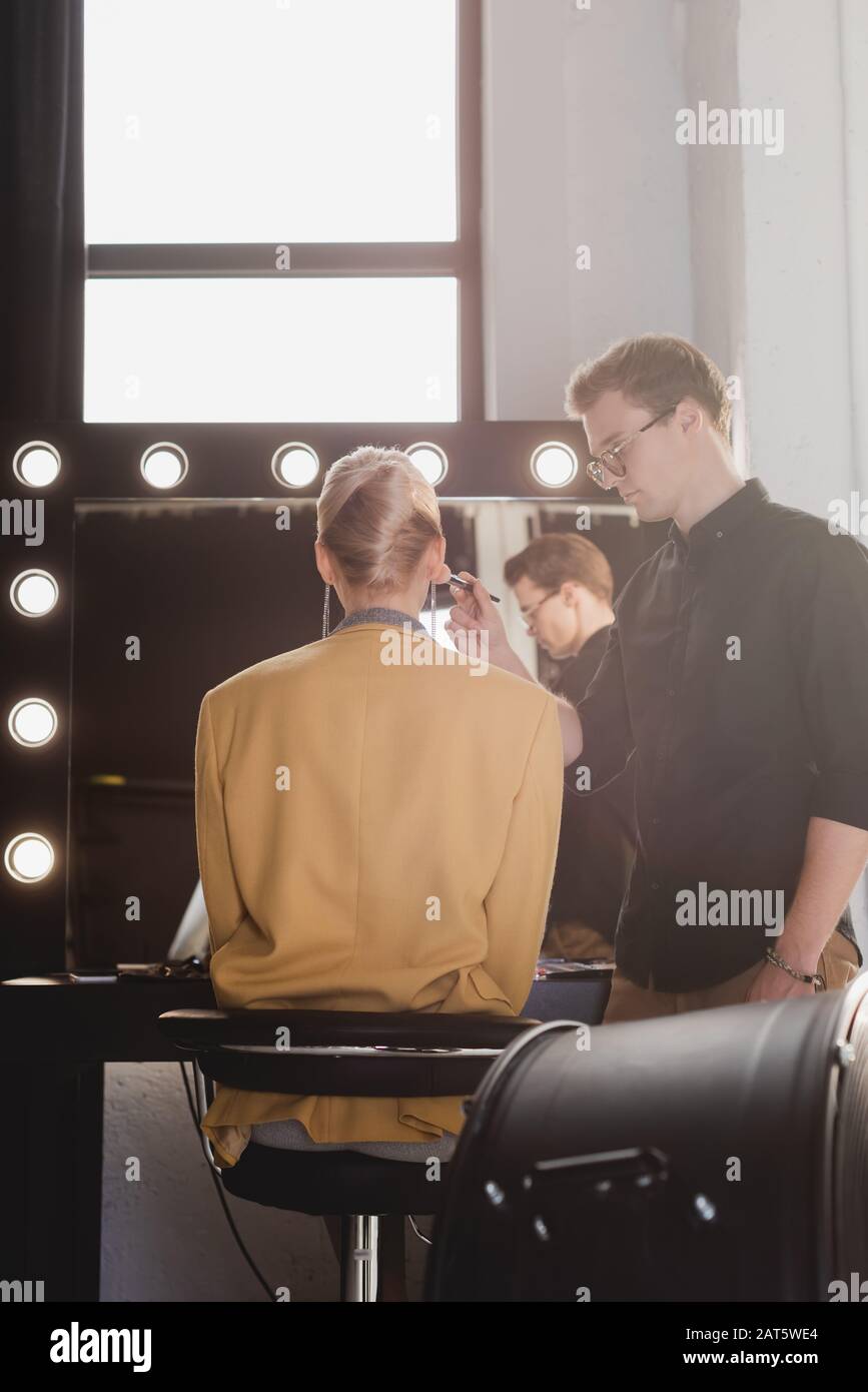 handsome Makeup Artist doing makeup to model on backstage Stock Photo ...