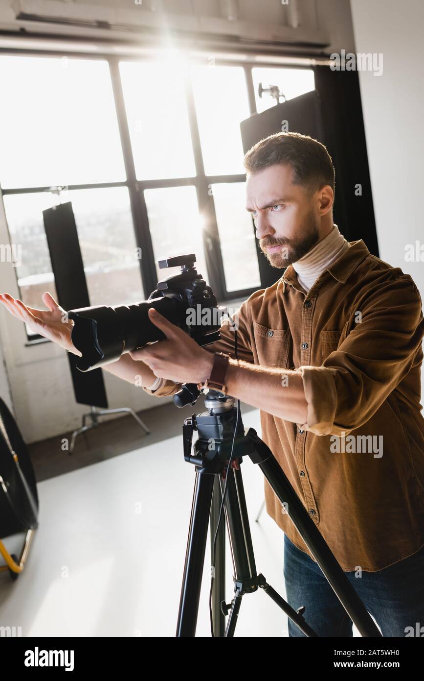 angry photographer taking photo with digital camera on backstage Stock ...