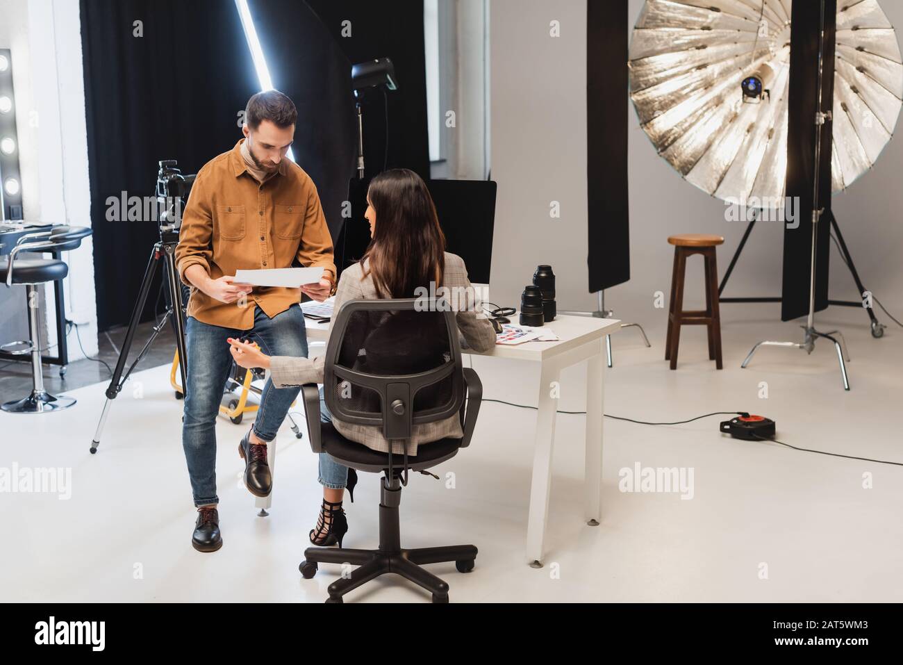 back view of producer and photographer talking on backstage Stock Photo ...