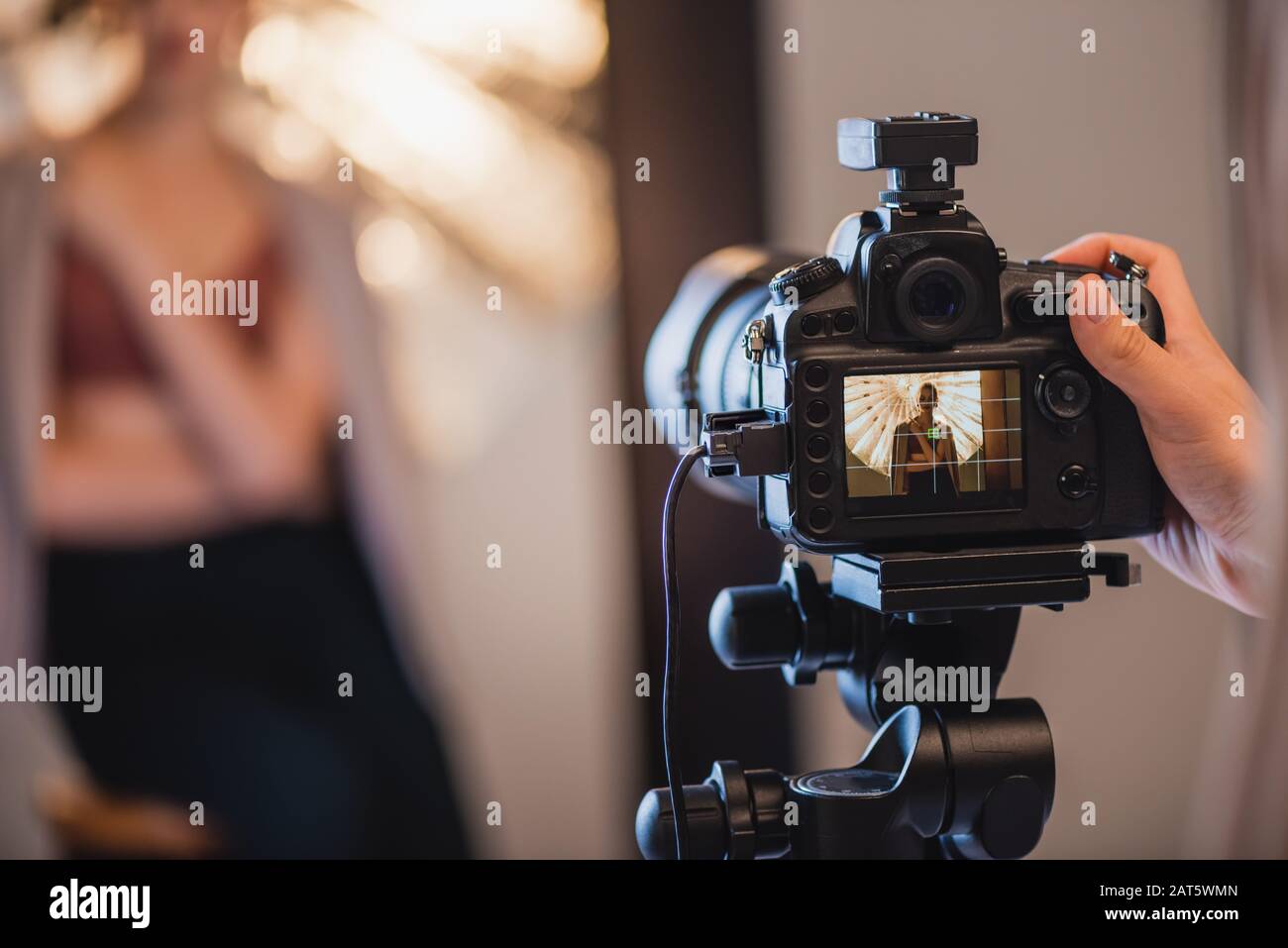 selective focus of photographer taking photo of stylish model Stock ...