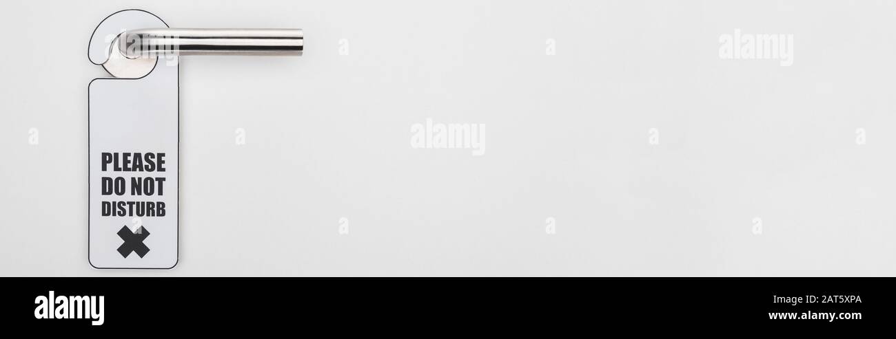 please do no disturb sign on handle on white background, panoramic shot ...