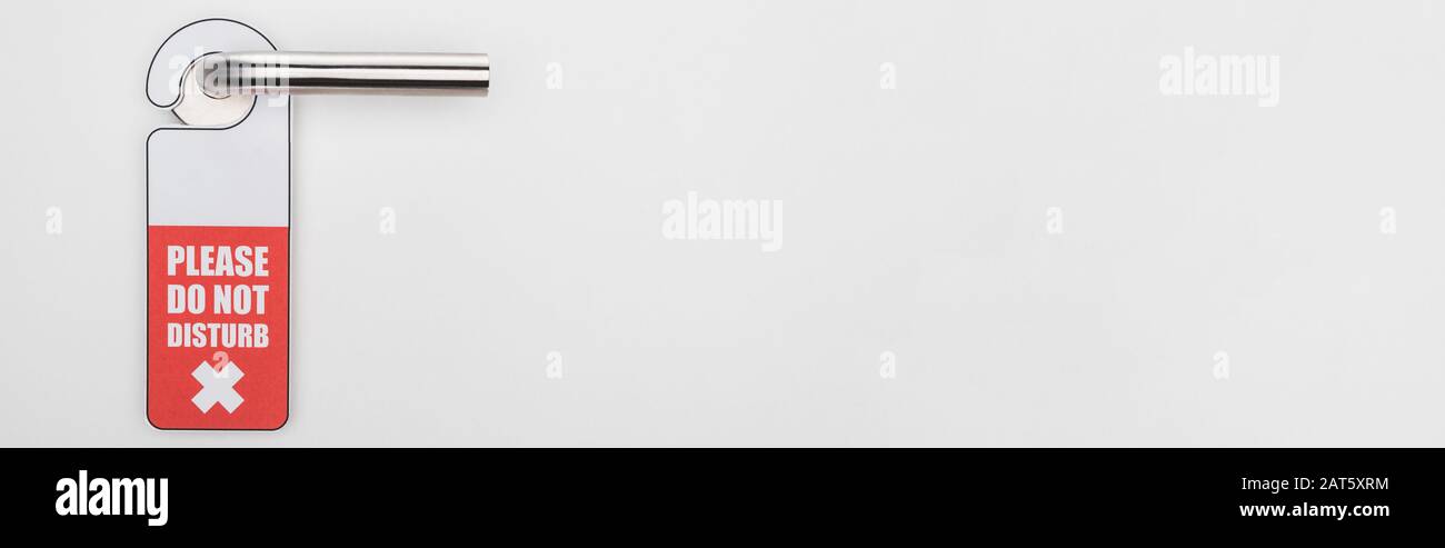 please do no disturb sign on handle on white background, panoramic shot ...