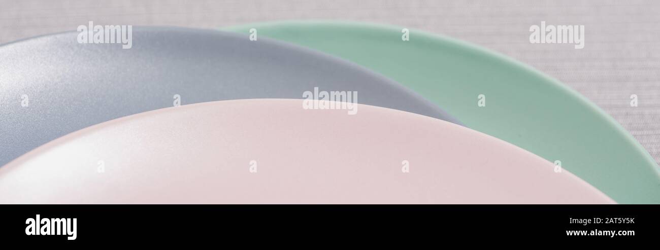 Colorful plates on grey surface, panoramic shot Stock Photo - Alamy