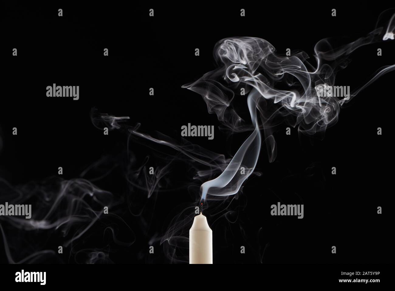 extinct white candle with smoke on black background Stock Photo - Alamy