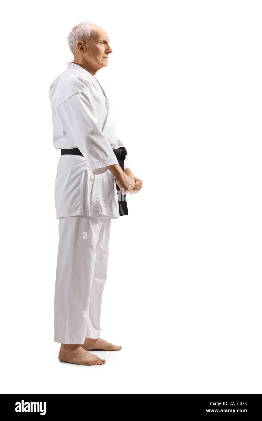 Full length profile shot of a senior man with a black belt in karate ...