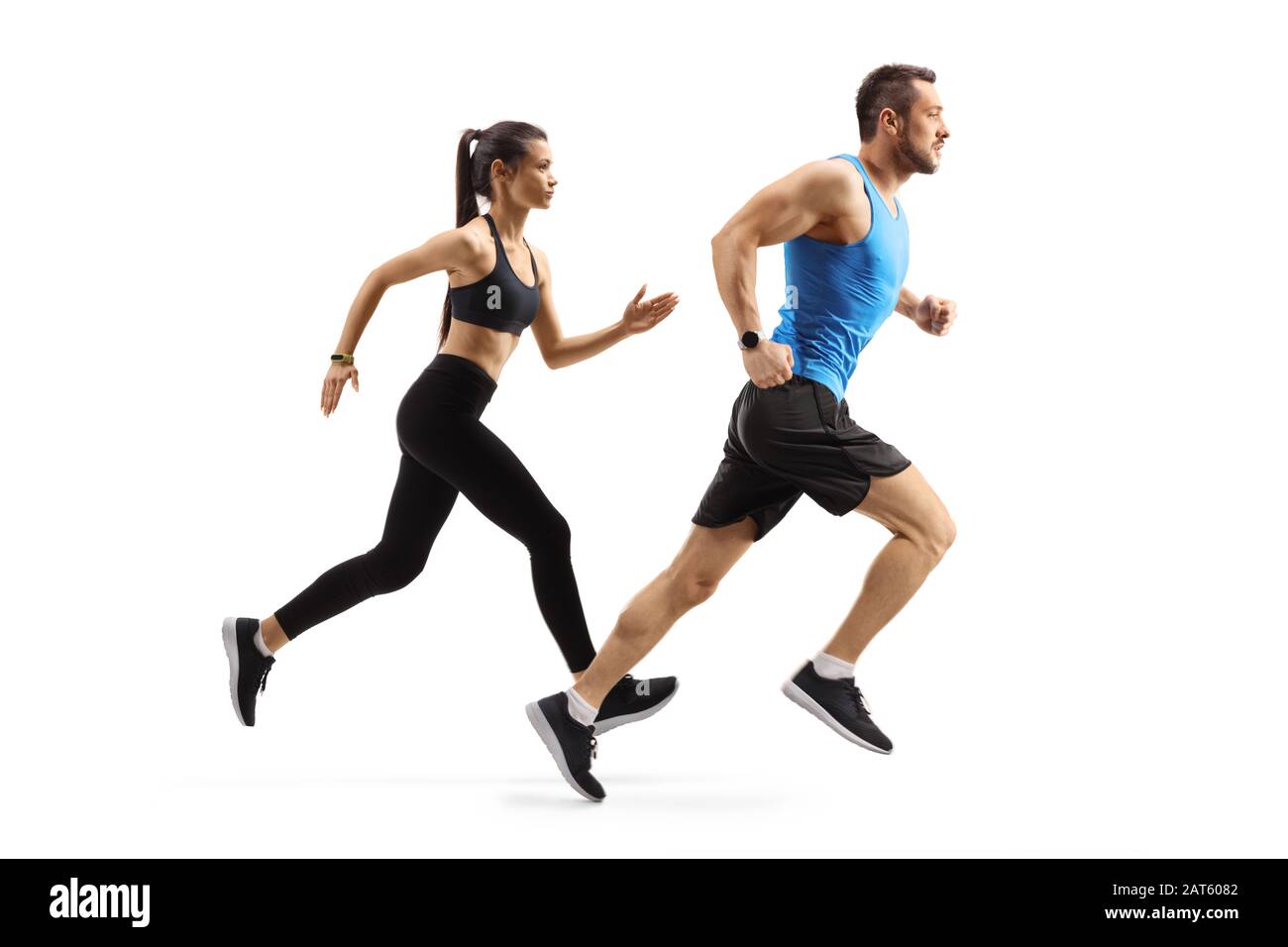 Full length profile shot of fit man and woman in sportswear running ...