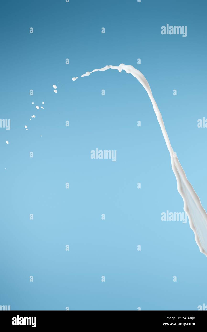 fresh white milk splash isolated on blue Stock Photo - Alamy