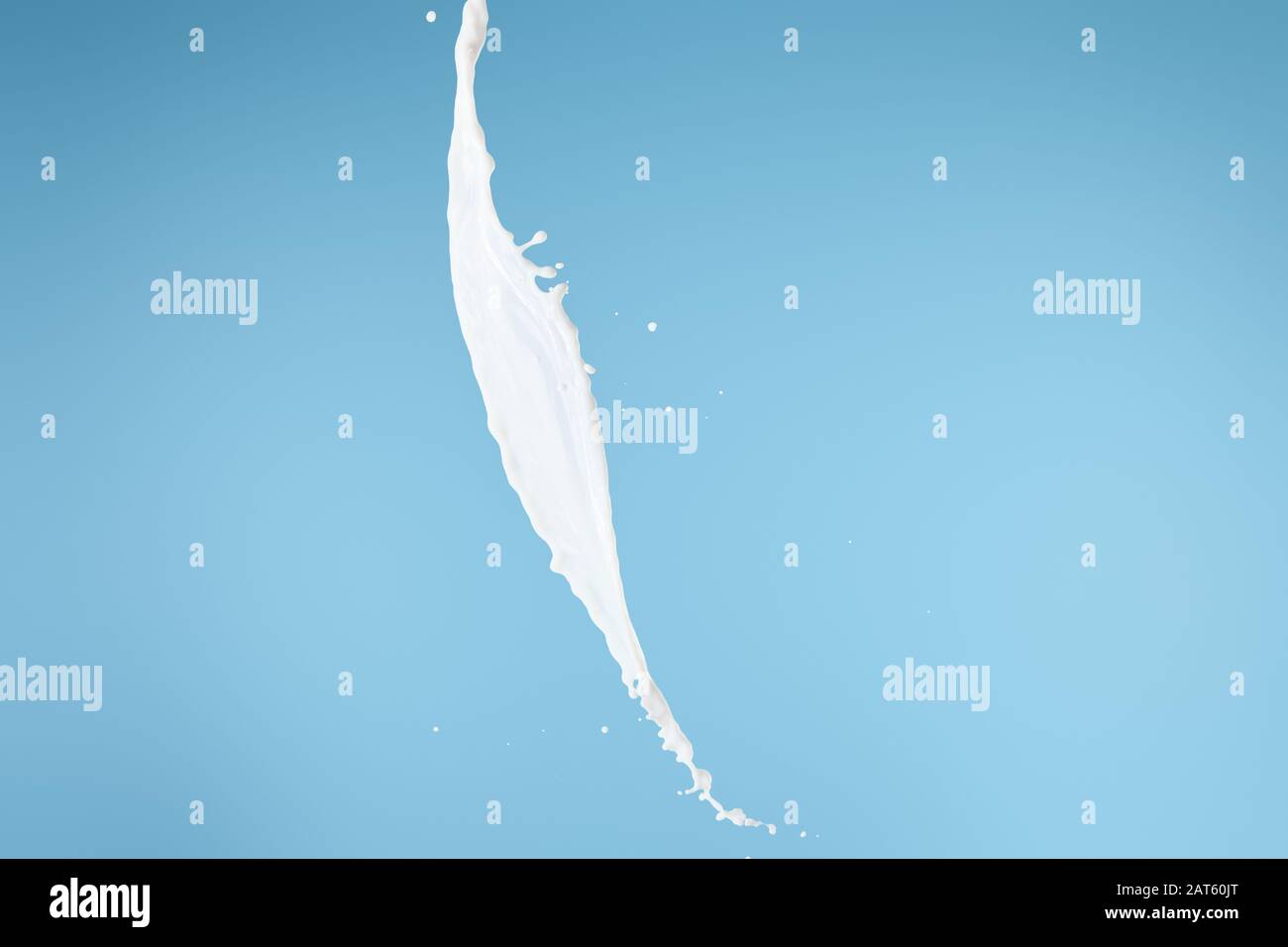 fresh white milk splash isolated on blue Stock Photo - Alamy