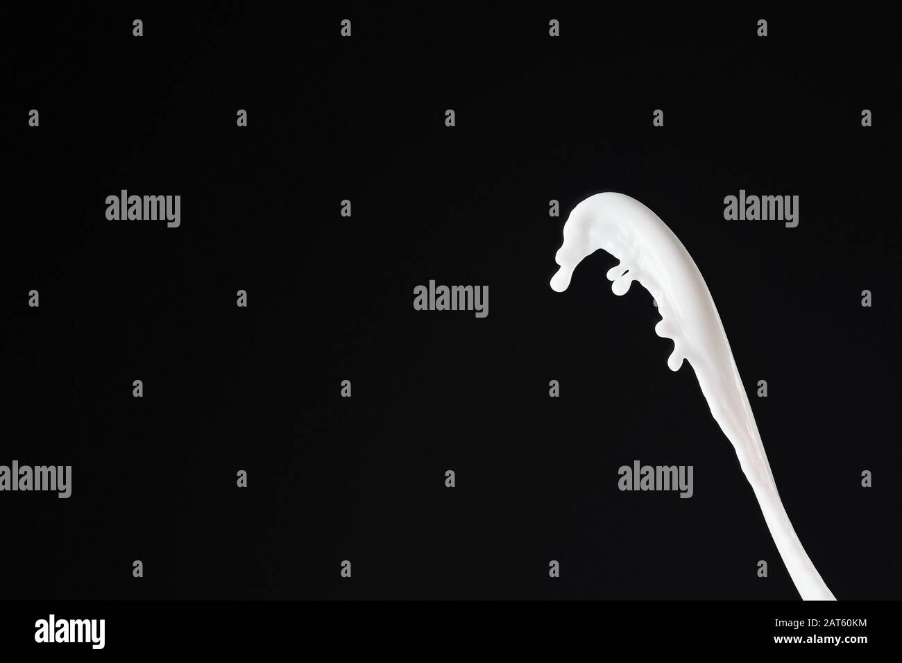 fresh white milk splash with drops isolated on black Stock Photo - Alamy