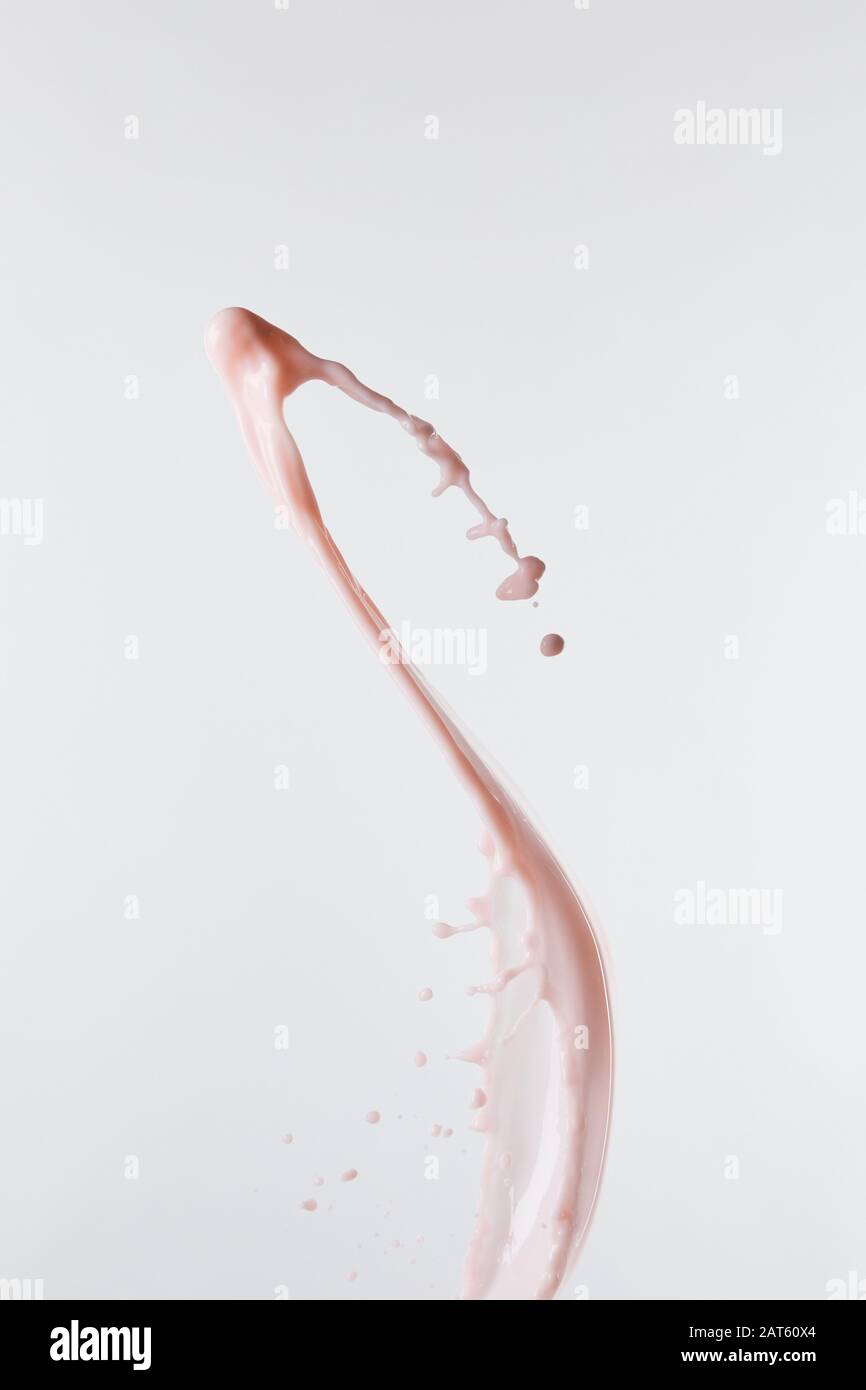 fresh pink milk splash with drops isolated on white Stock Photo - Alamy