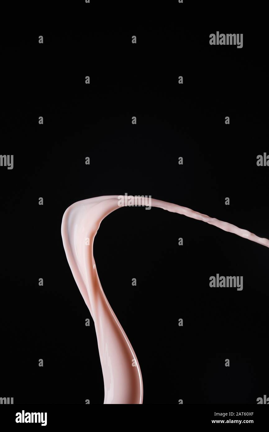 smooth fresh pink milk splash isolated on black Stock Photo - Alamy