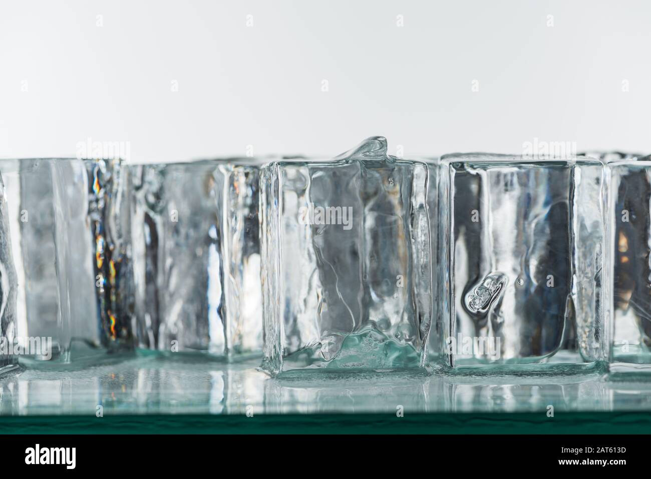 selective focus of melting transparent clear square ice cubes isolated ...