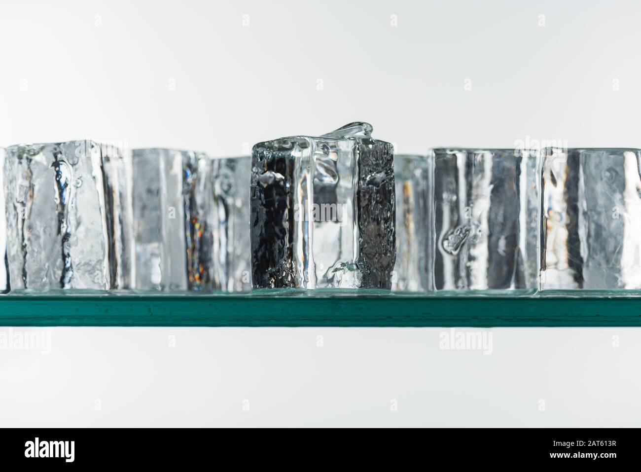 selective focus of transparent clear square ice cubes in line isolated ...