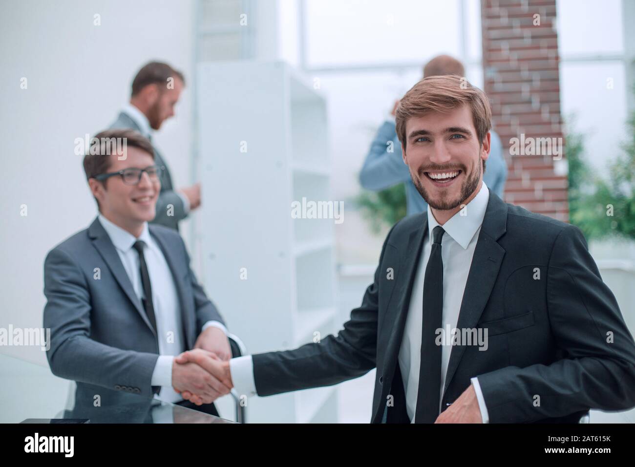 happy entrepreneur shaking hands with his business partner Stock Photo ...
