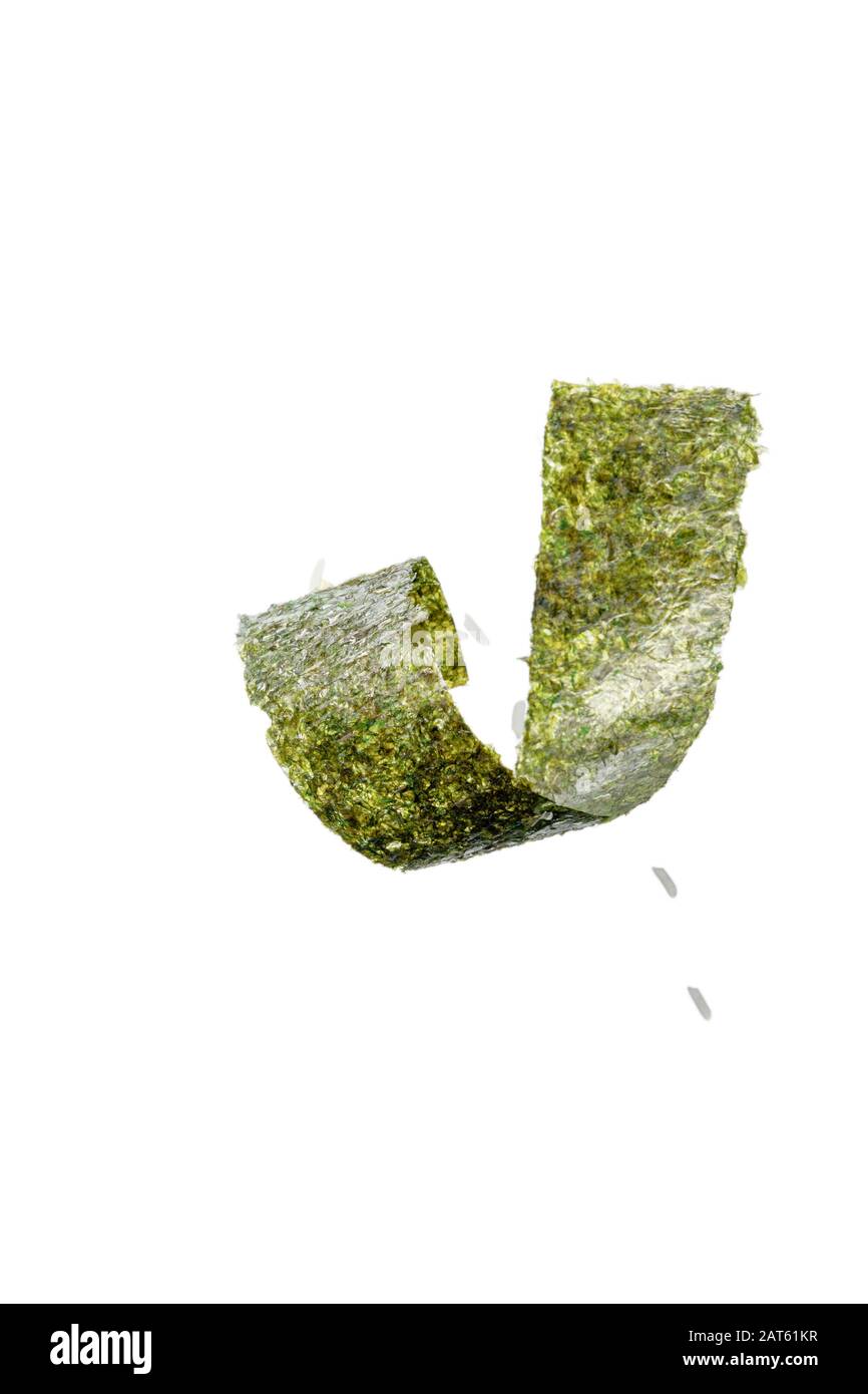 top view of twisted nori seaweed piece and rice isolated on white Stock ...