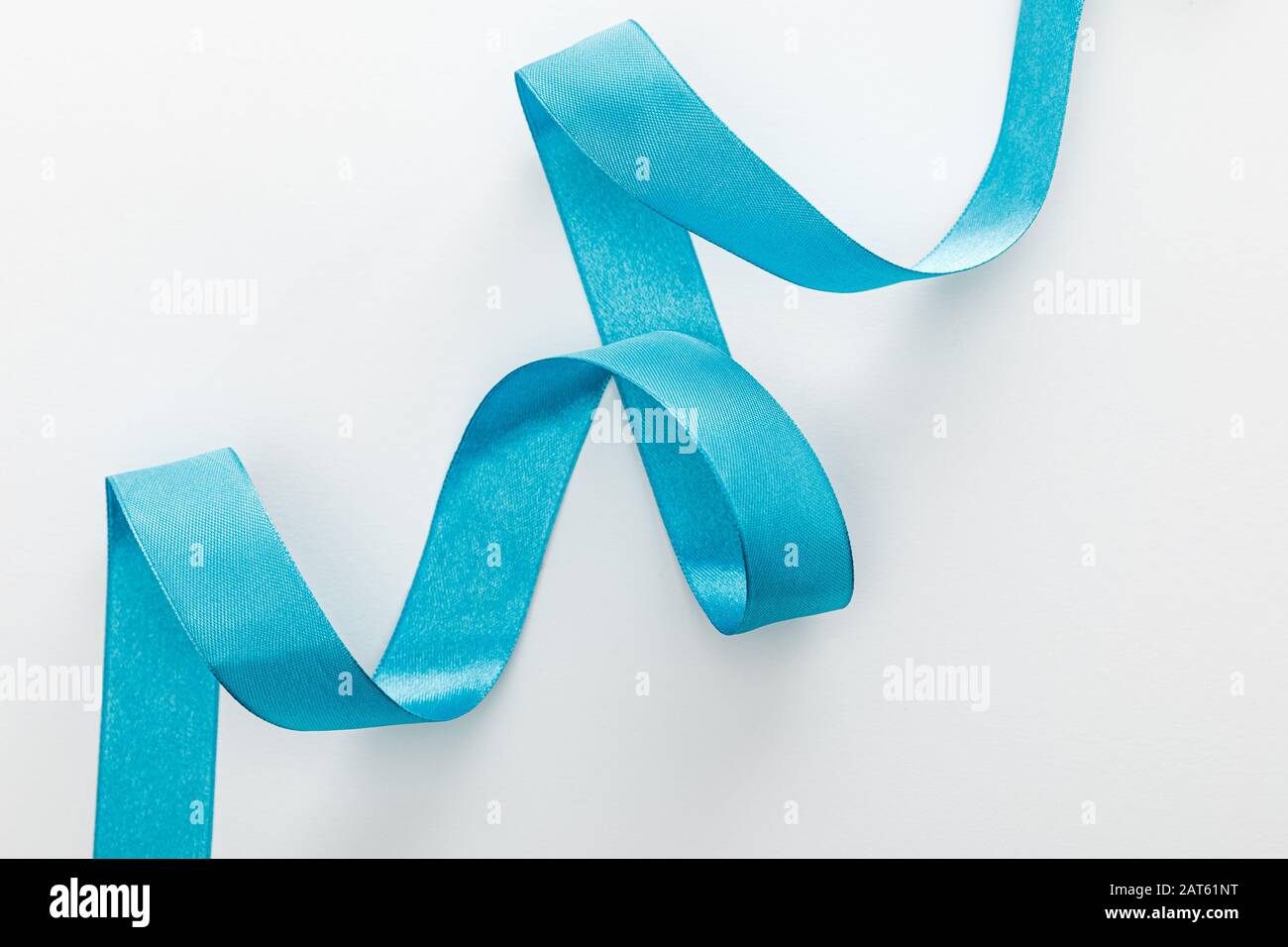 top view of blue decorative curved ribbon on white Stock Photo - Alamy