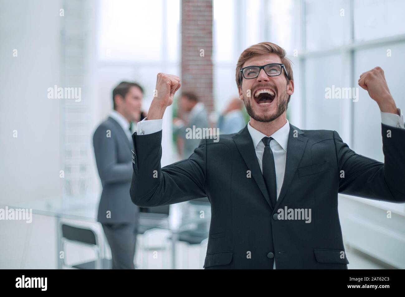 portrait of a very happy businessman on an office background Stock ...
