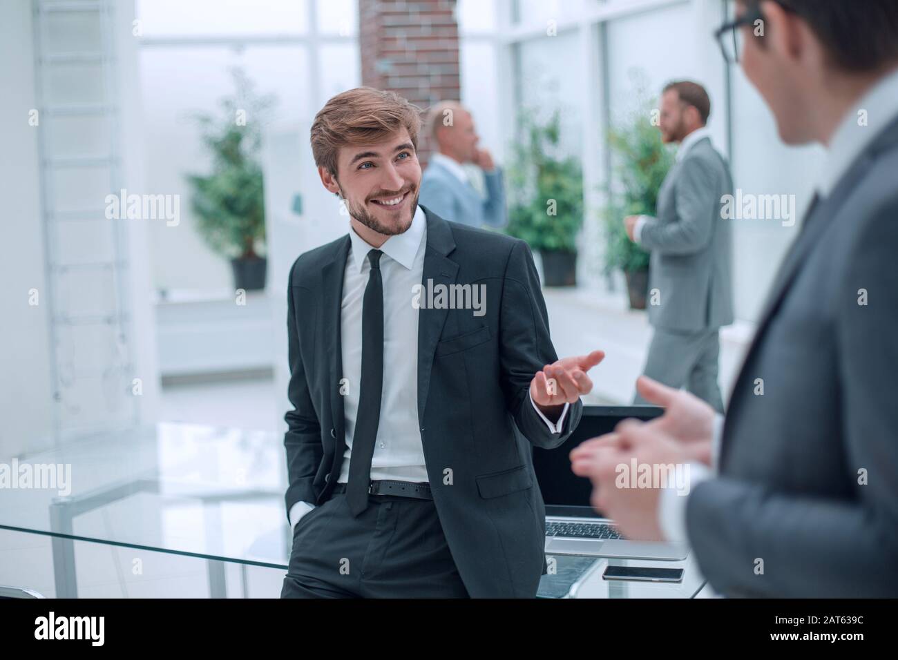 employees discuss their ideas standing in the office lobby Stock Photo ...