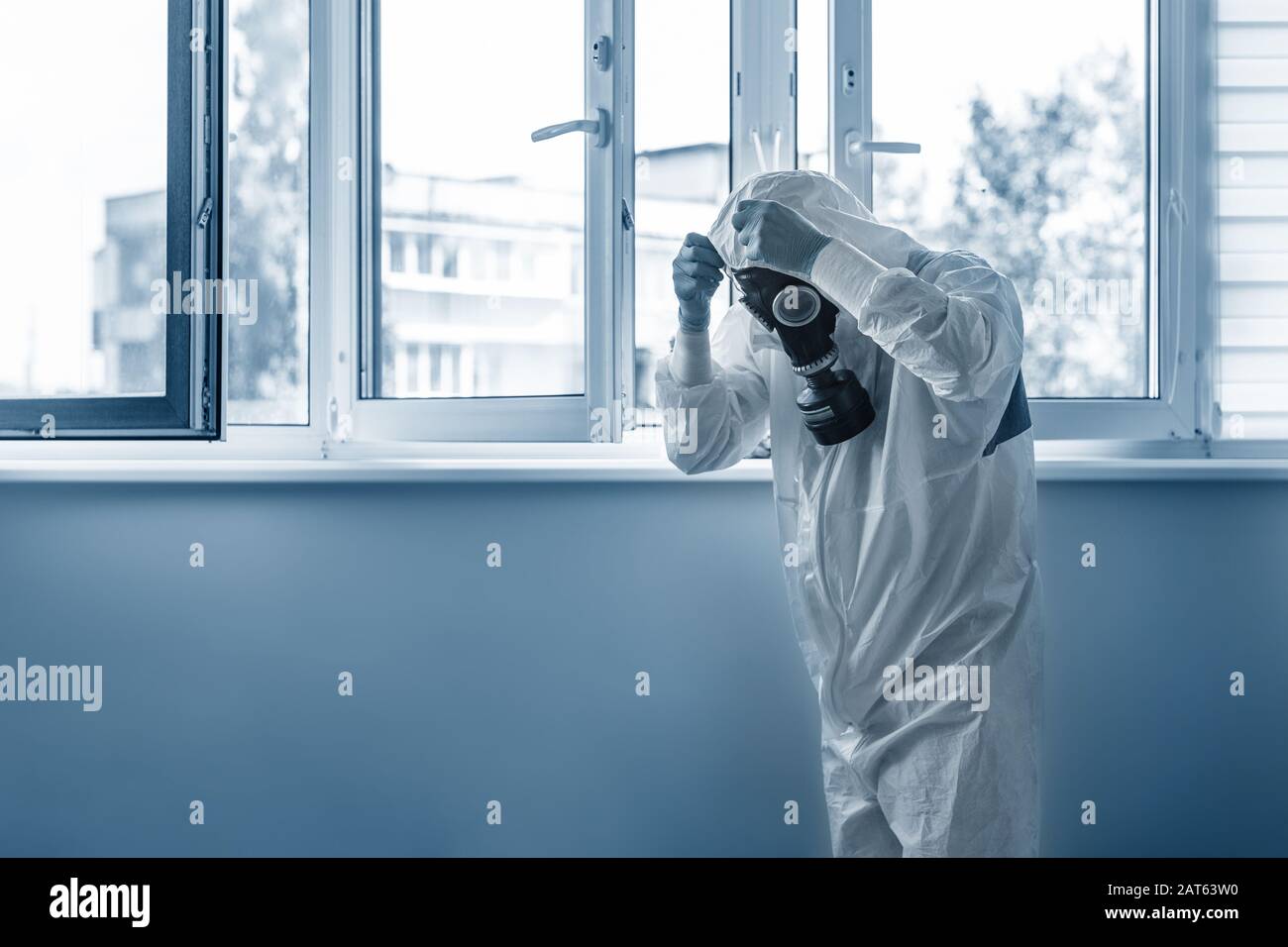Man wearing protective biological suit and gas-mask due to mers ...
