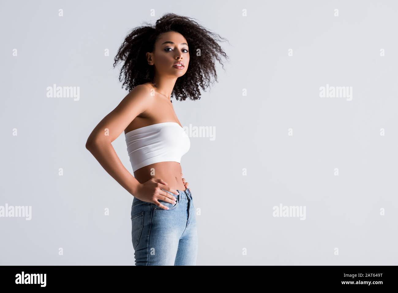 african american woman in white top isolated on grey Stock Photo - Alamy