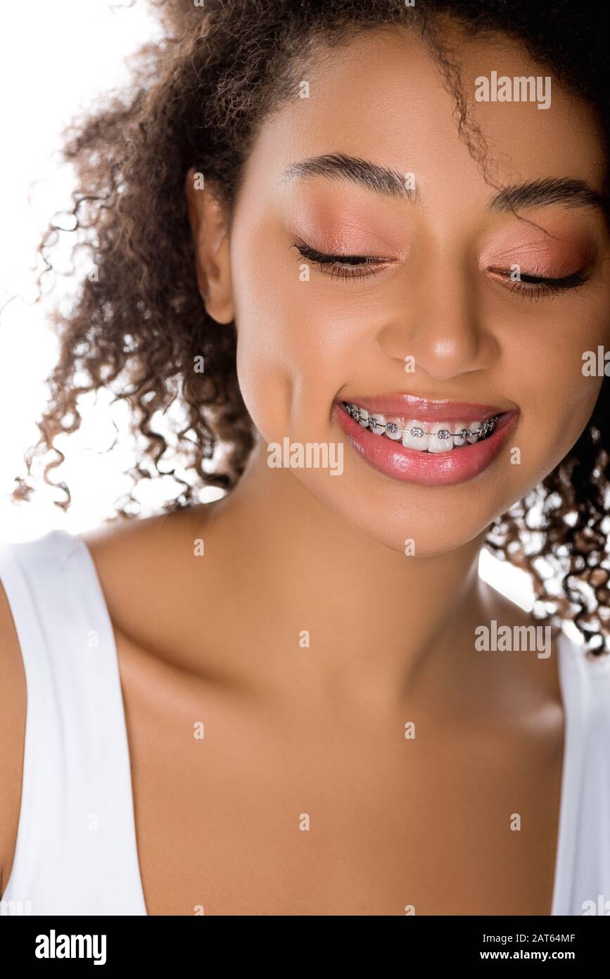 beautiful smiling african american girl with dental braces, isolated on ...