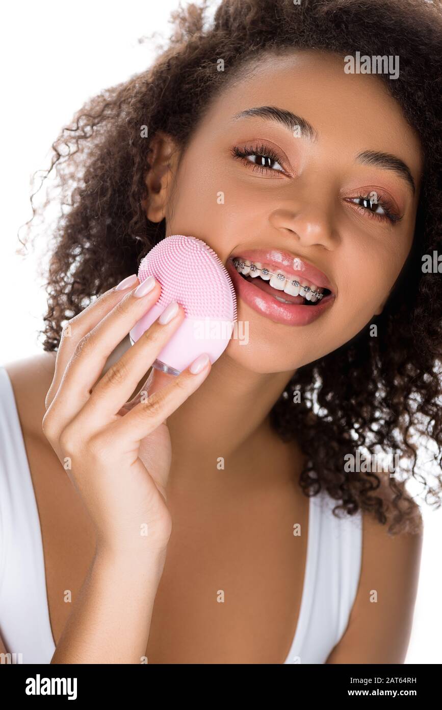 happy african american girl with dental braces using silicone cleansing ...