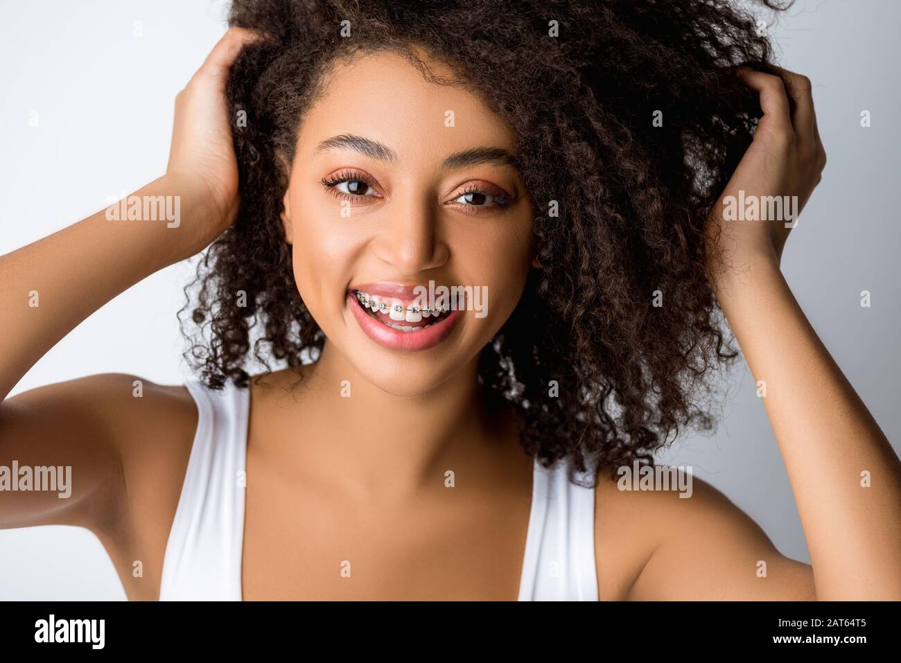 beautiful positive african american girl with dental braces, isolated ...