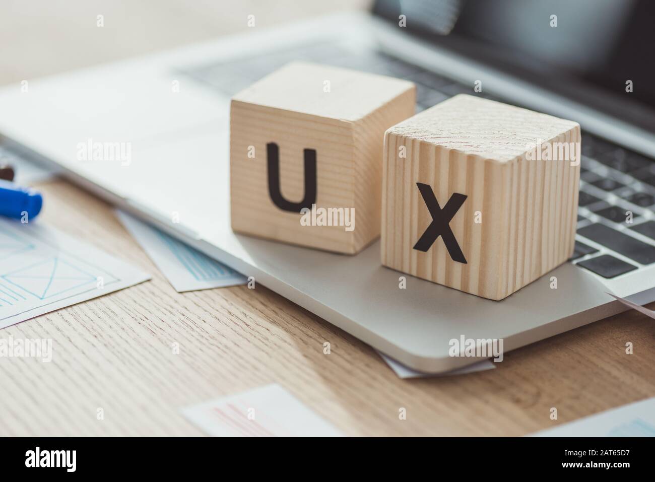 Selective focus of ux letters on cubes on laptop with web sketches on table Stock Photo - Alamy