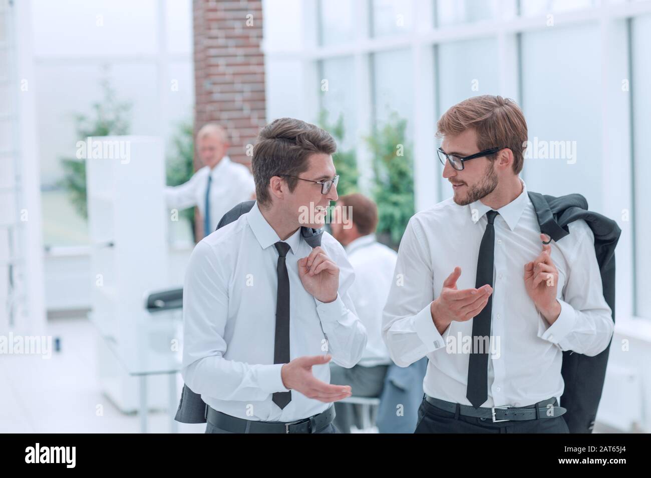 business colleagues discussing something in the workplace Stock Photo ...