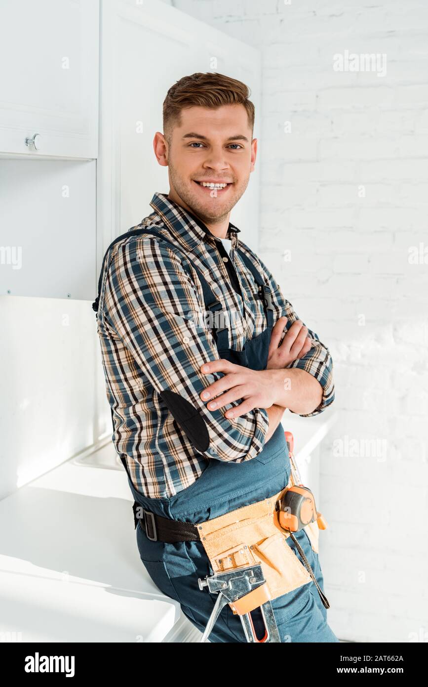 happy installer standing with crossed arms Stock Photo - Alamy
