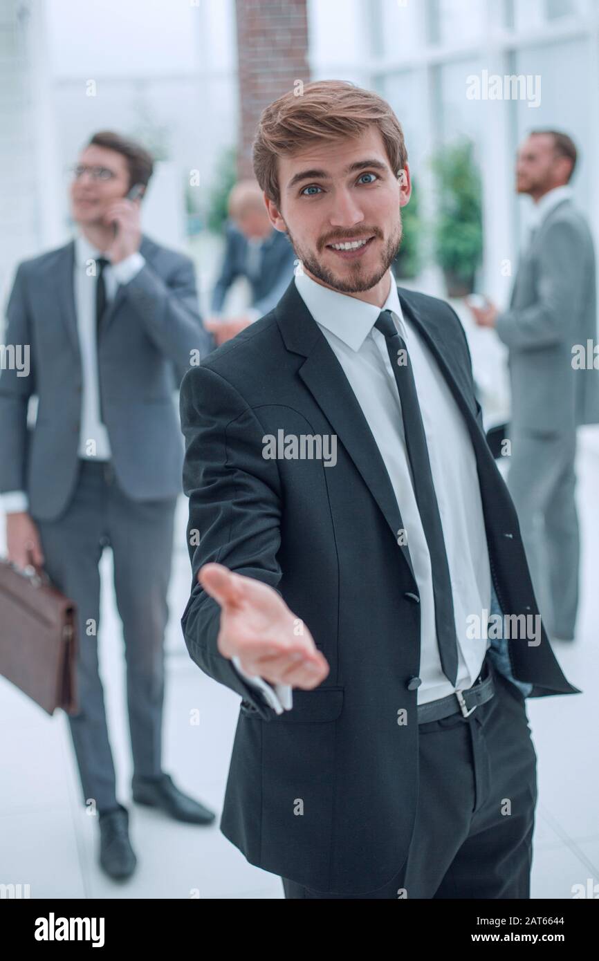 smiling business man holding out his hand for a handshake Stock Photo ...
